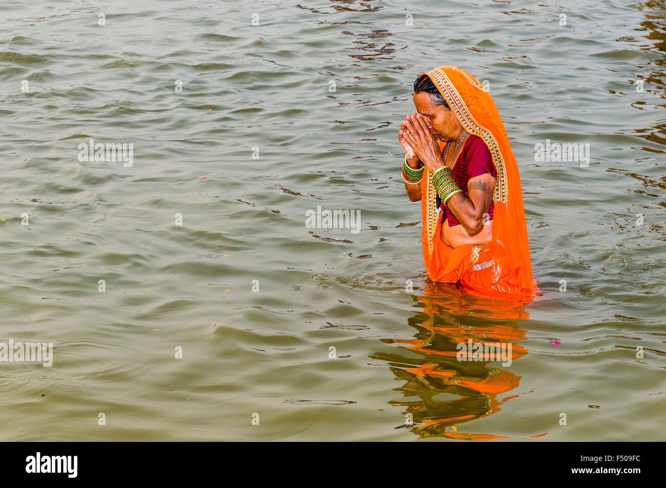 Woman Praying By The Water