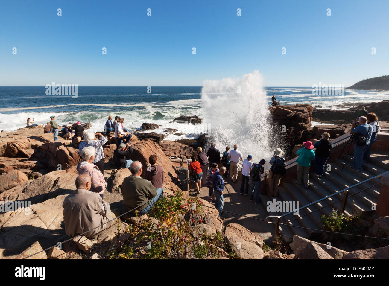 Tourists watching the waves crashing onto the rocks, Thunder hole ...