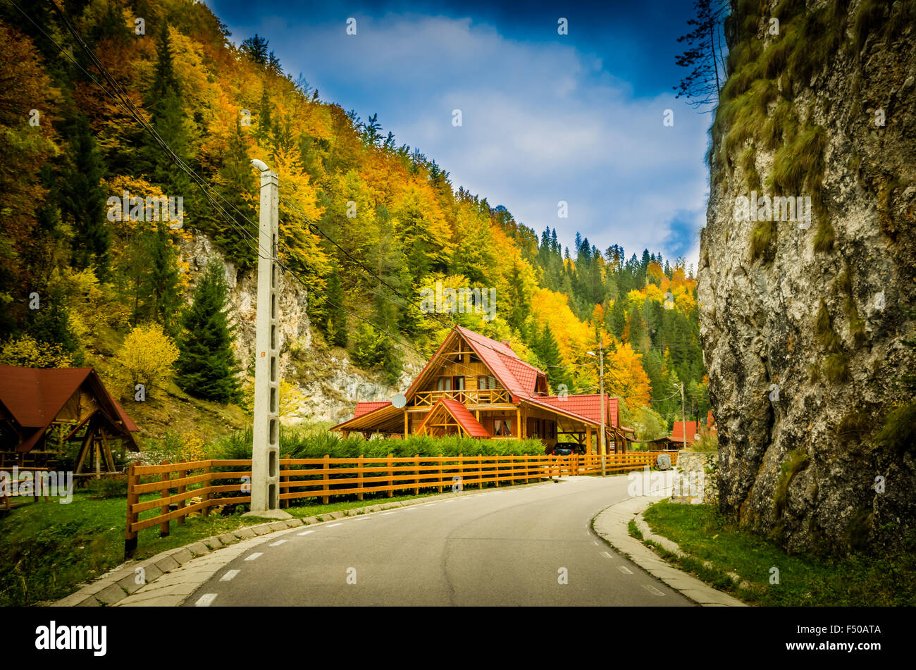 Fall colors around a cottage house. Autumn landscape in mountains with ...