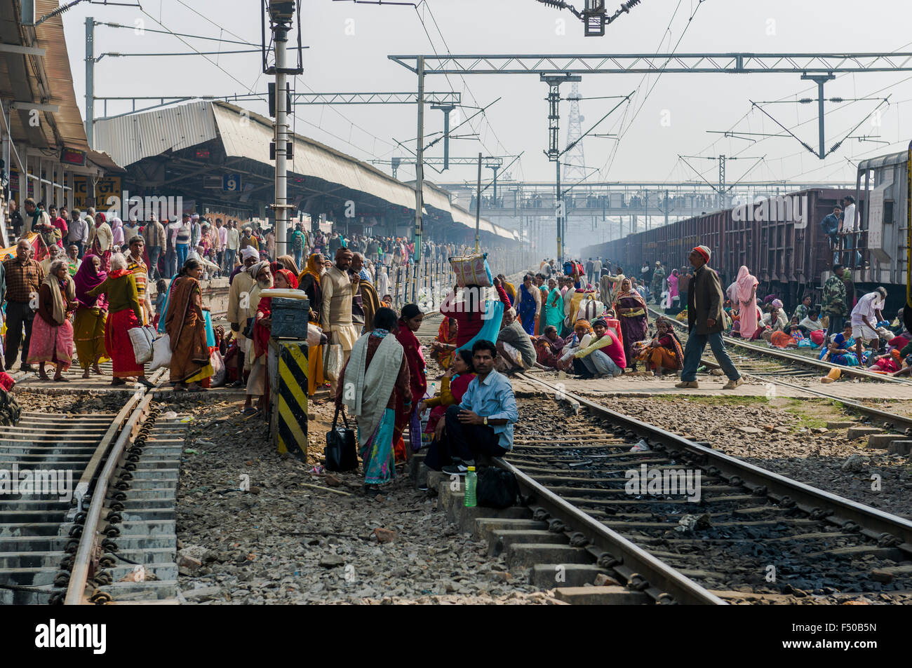 Many people waiting for delayed trains all over the railwaystation ...