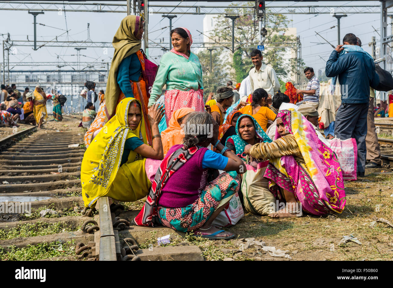 Many people waiting for delayed trains all over the railwaystation ...