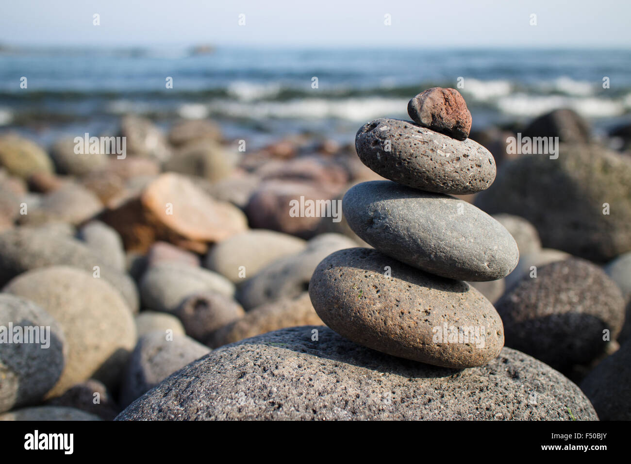 Smooth stacked stones on a rock beach on Jeju Island, South Korea Stock ...