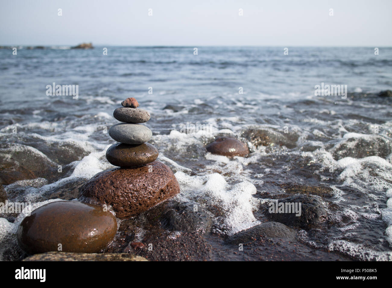 Stacked rocks in the surf on Jeju Island in South Korea Stock Photo - Alamy