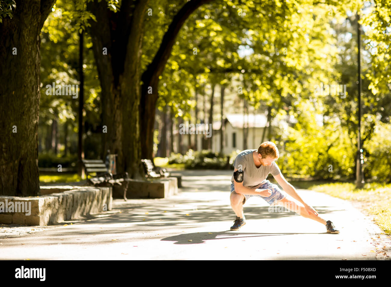 Young man having a workout in the autumn park Stock Photo - Alamy