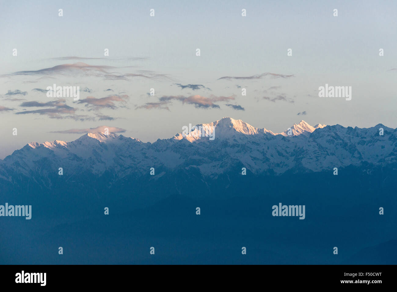 Snow capped mountains of the Great Himalayan Range are lit by the first ...