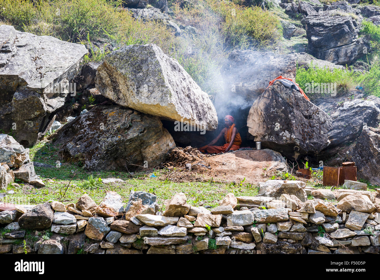 A Sadhu, holy man, is meditating in a cave in the hills above town ...