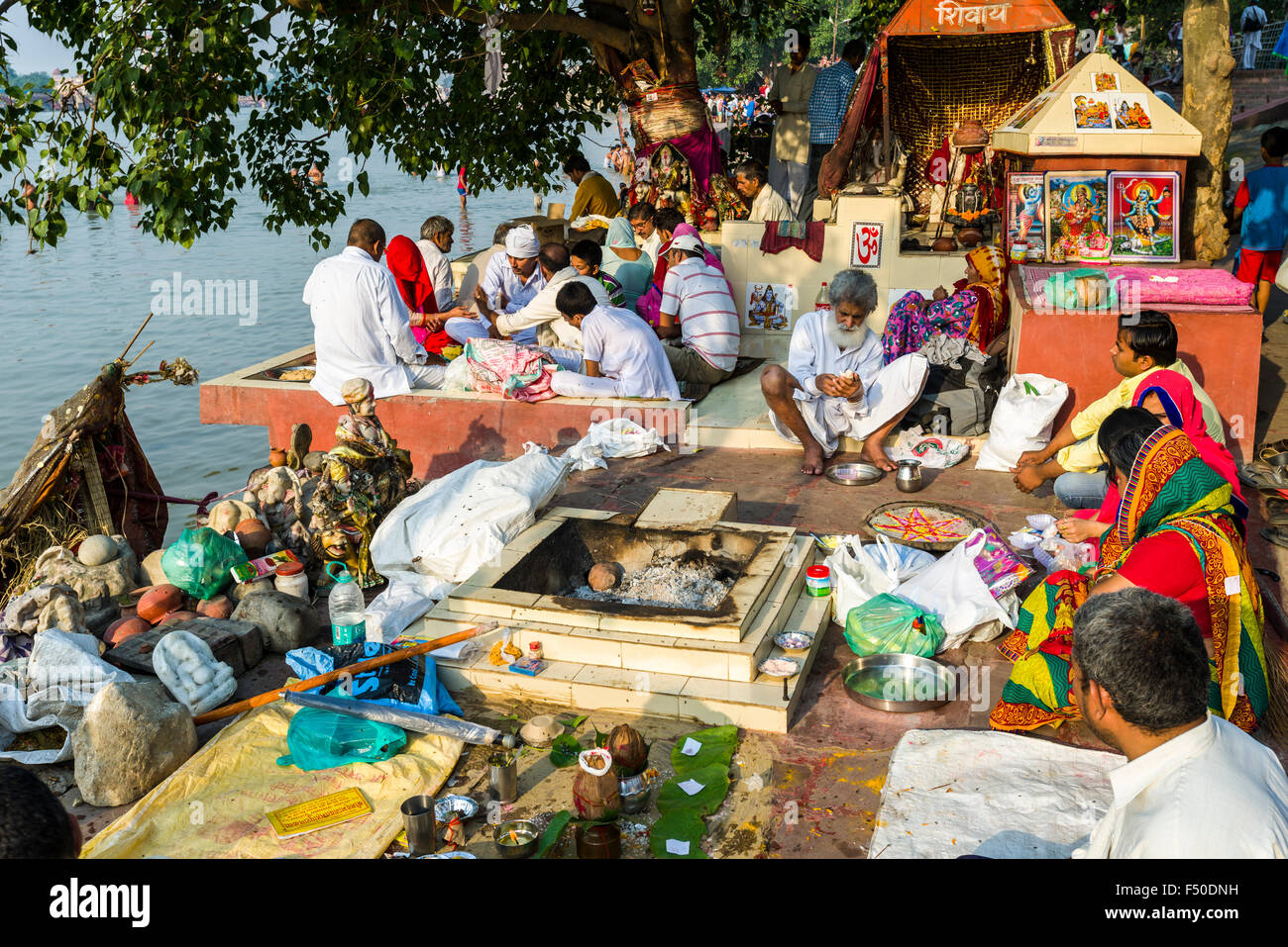 A group of pilgrims at the banks of the river Ganges is performing ...