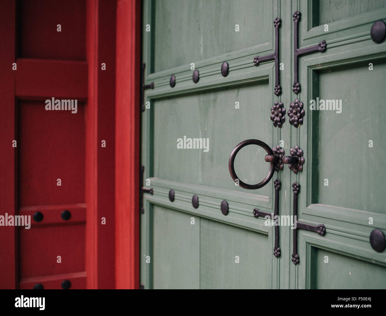 A green wooden door with iron details inside the Gyeongbokgung Palace ...