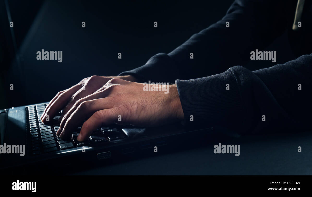 Hacker man typing on laptop computer keyboard Stock Photo - Alamy