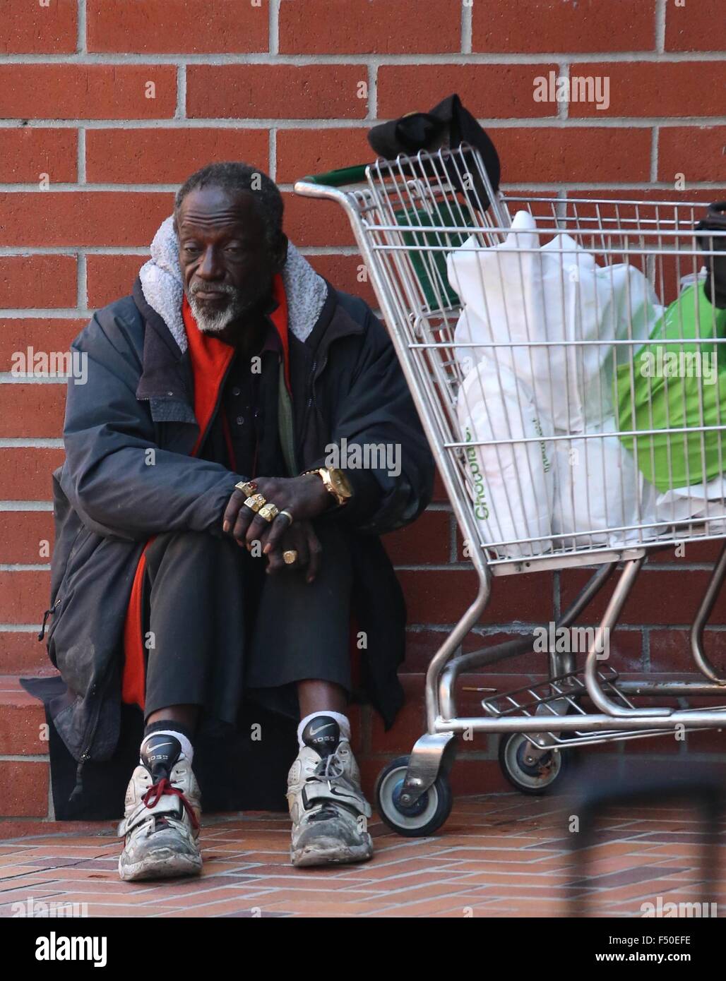 Homeless man wears a gold watch and gold jewelry Where: Los Angeles ...