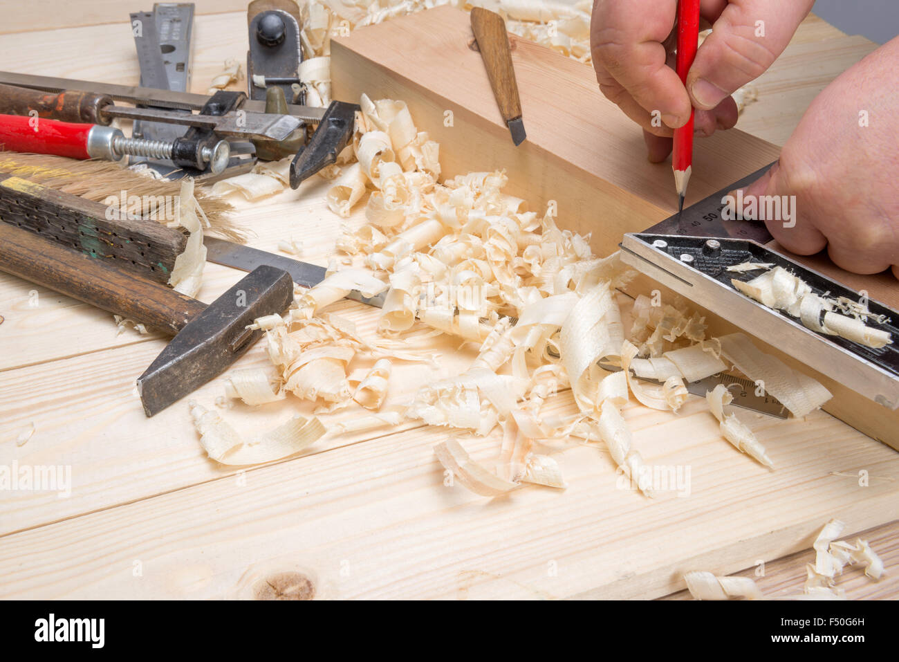 carpentry tools and wood shavings in the furniture workshop Stock Photo ...