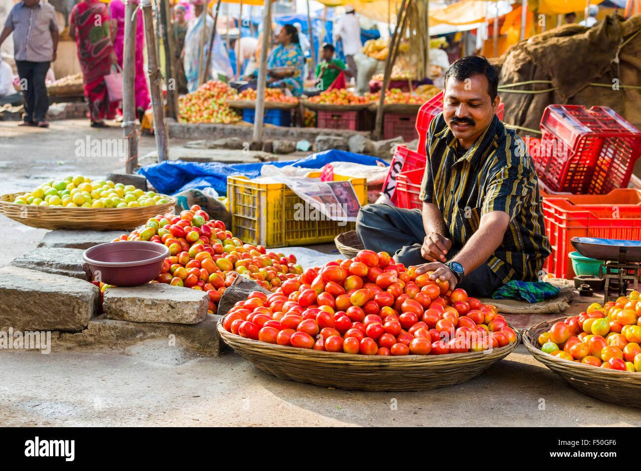 A man is selling tomatoes at the weekly vegetable market Stock Photo ...