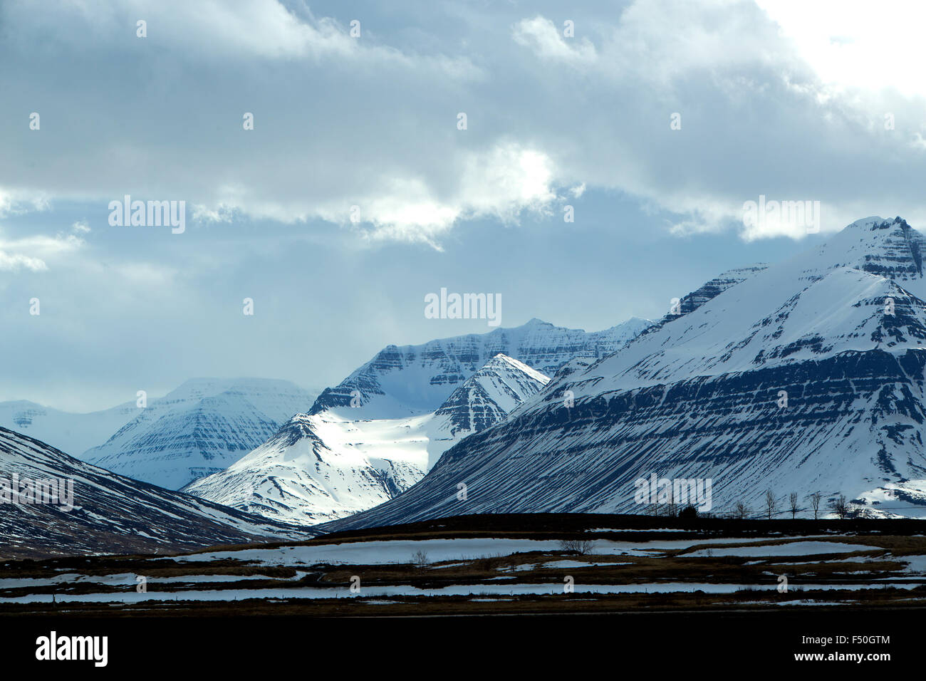 Snow-covered volcanic mountain landscape in Iceland Stock Photo - Alamy