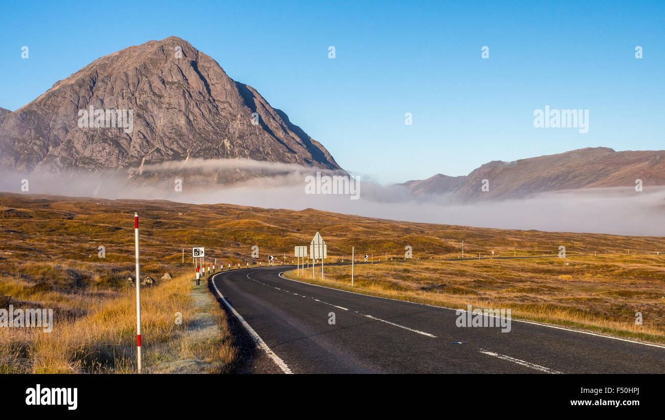 The road through Glencoe, early morning mist in the Glen on a sunny ...