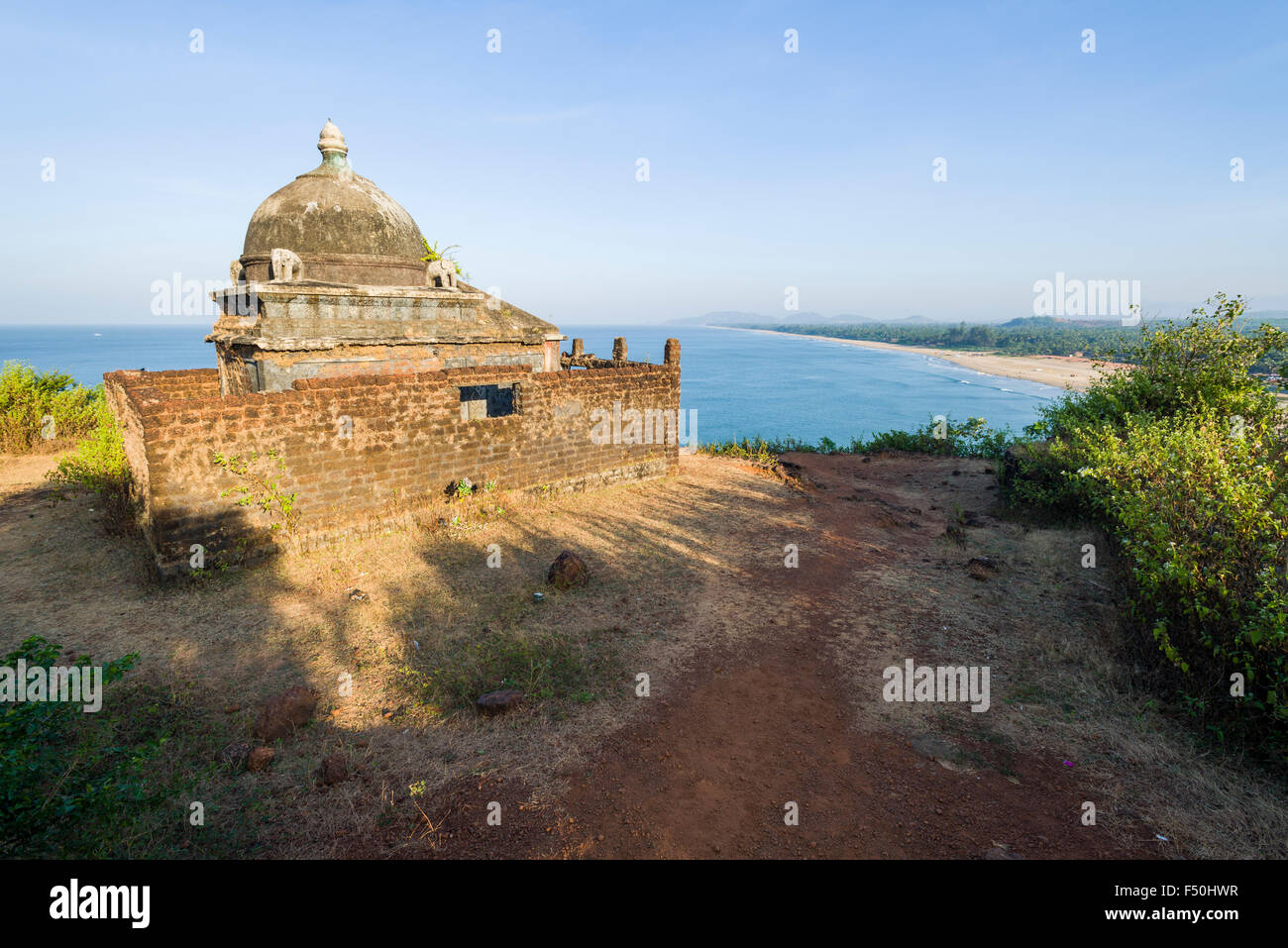 A small temple high above the beach and the blue sea Stock Photo - Alamy