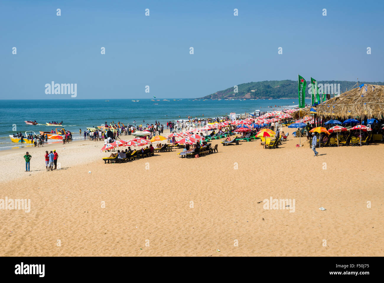 The Calangute Beach with sunshades, blue sky, white sand and blue sea ...