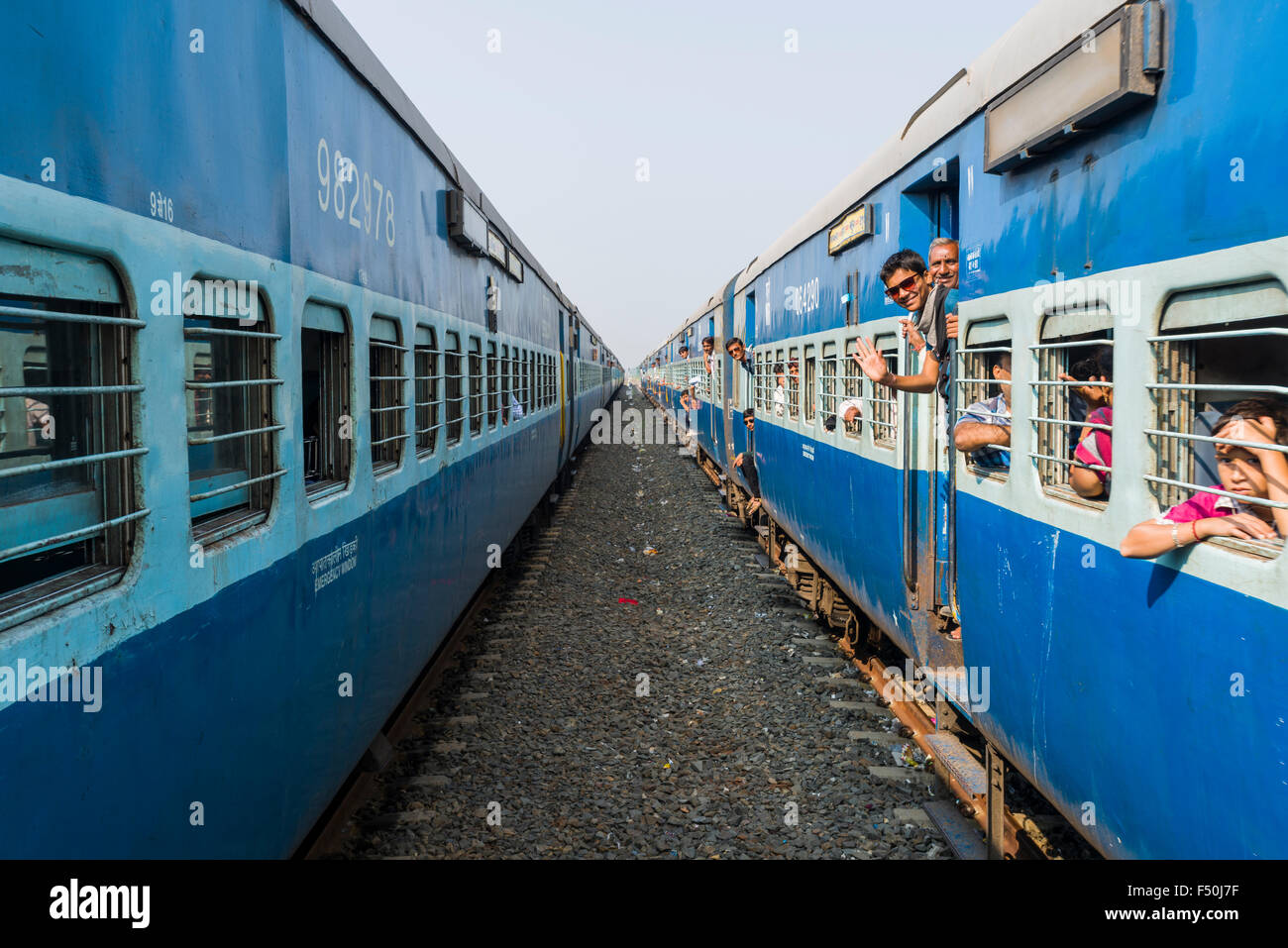 Two blue colored trains of Indian Railways are facing each other ...