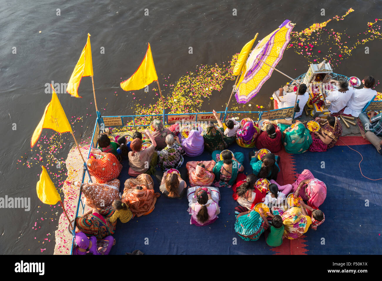 Some female pilgrims, women, are celebrating a ritual, pooja, on the ...