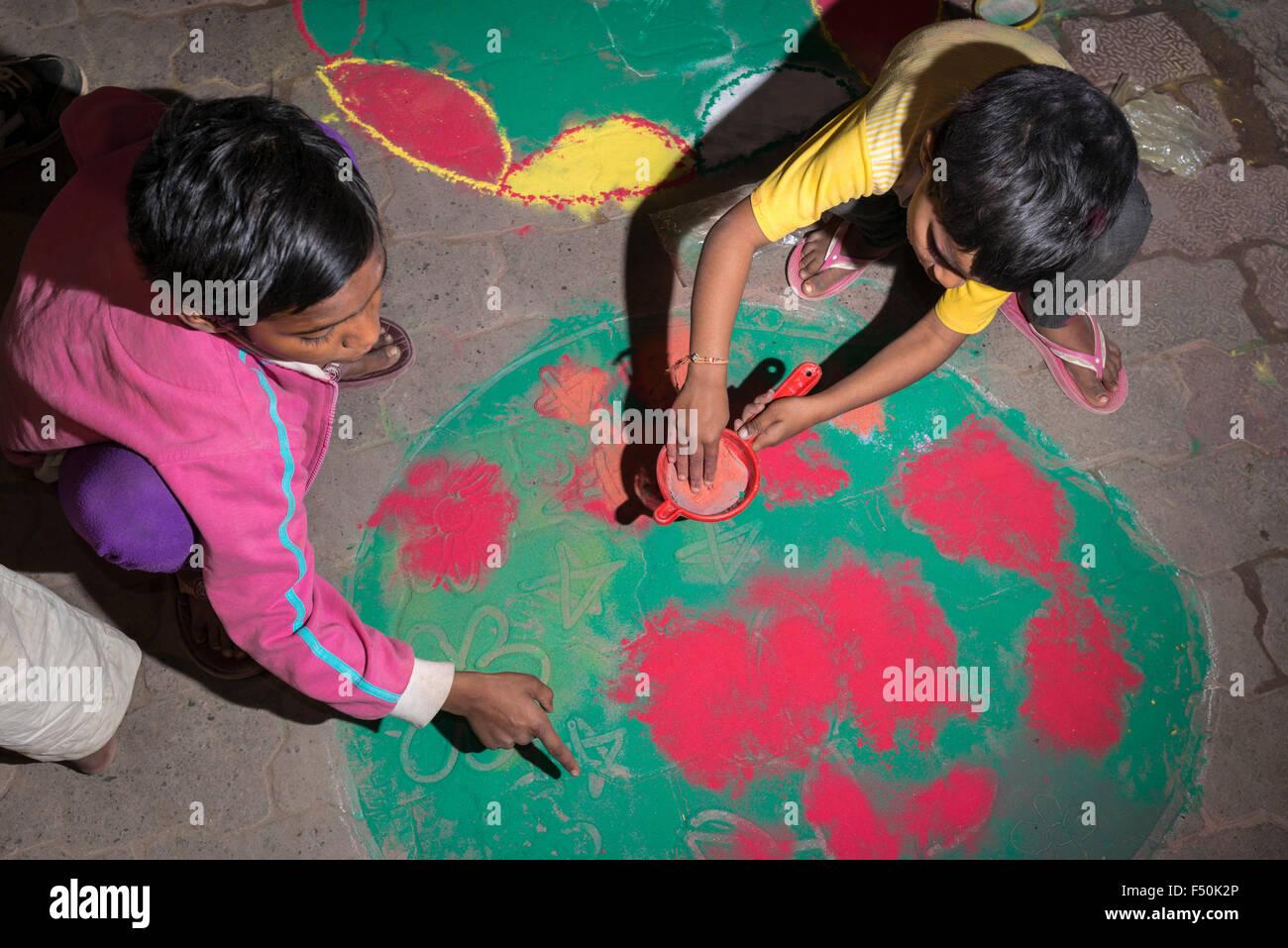 Children are creating artful Rangolis, made by colorpowder, at Holi ...