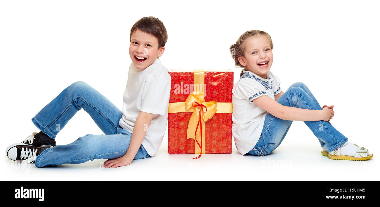 boy and girl with red gift box and golden bow - holiday object concept ...