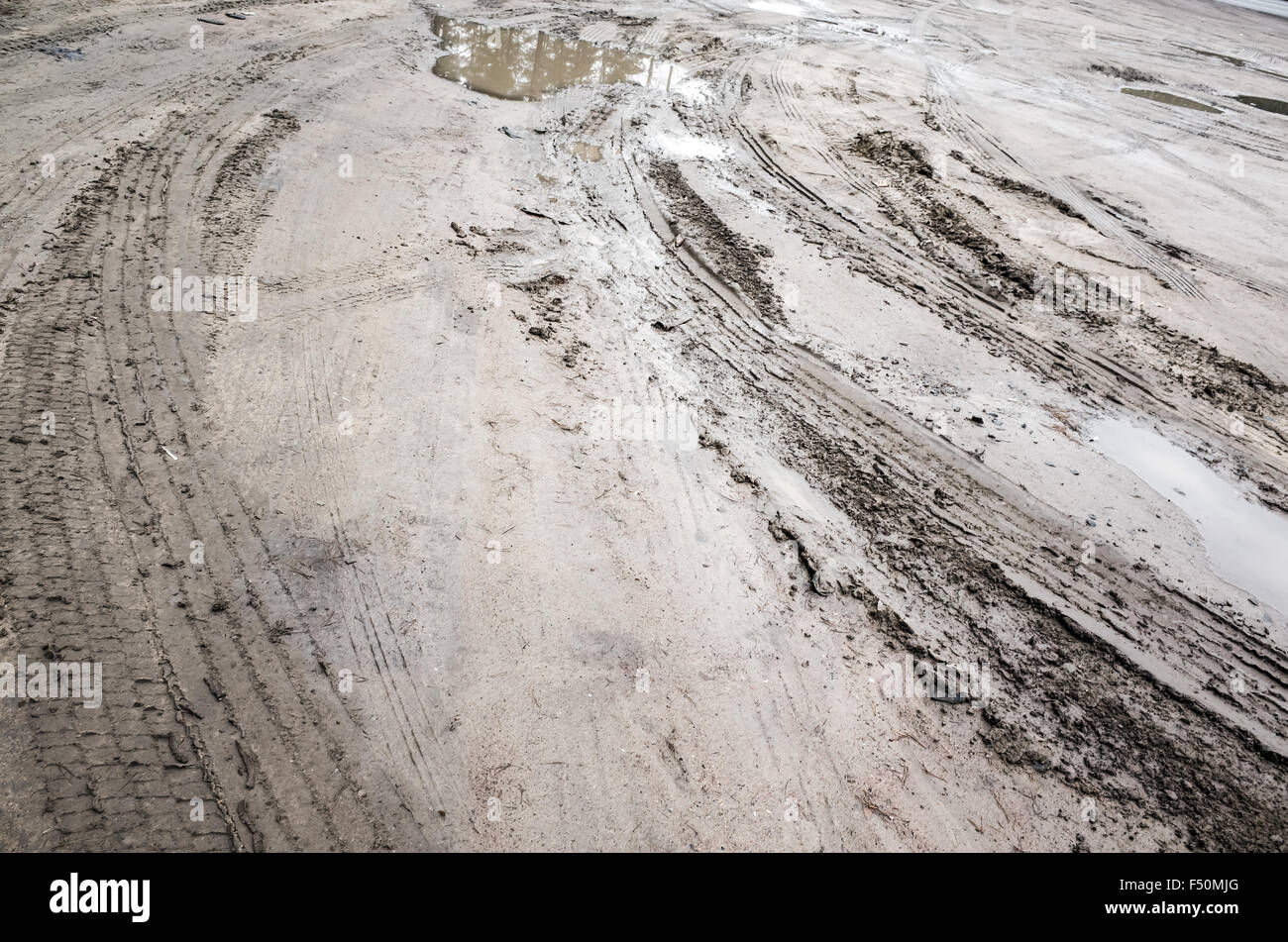 Tire tracks over rural mud dirty road with puddles Stock Photo - Alamy