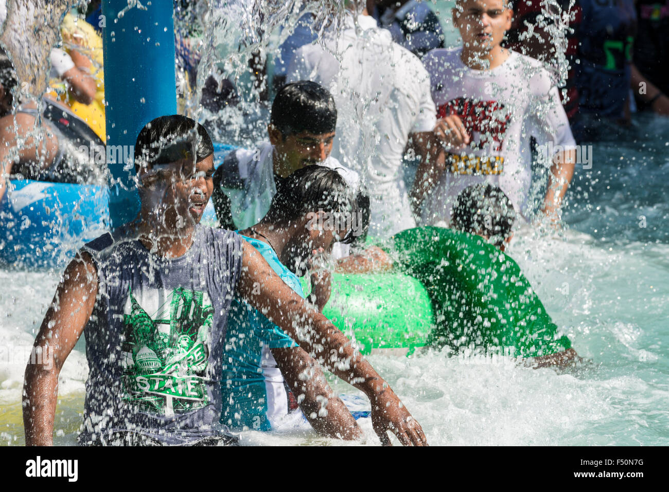 People play in water fountains at Wonder La, the big amusement park ...