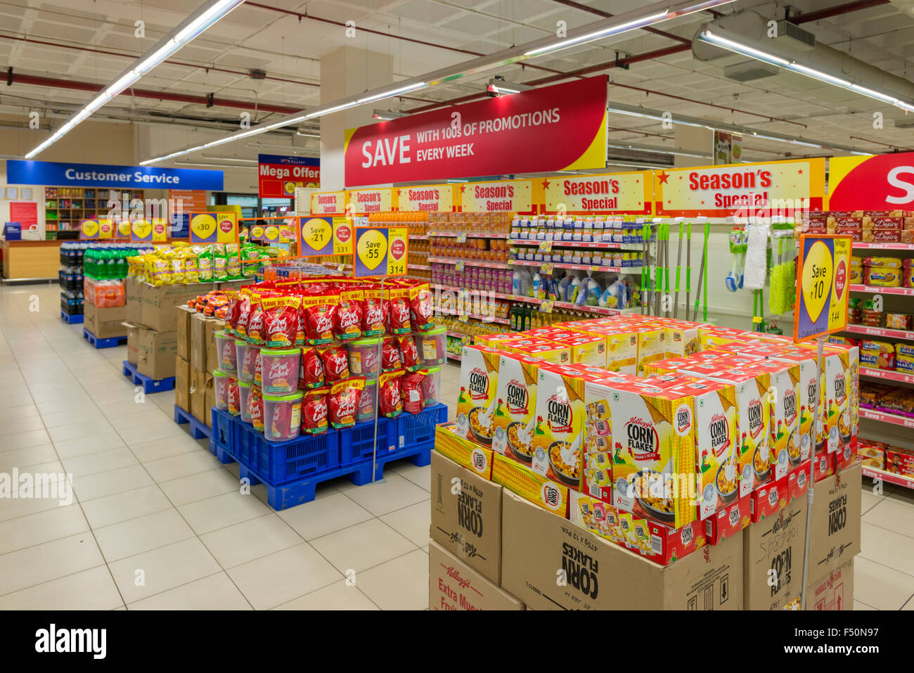 Different goods are for sale with discount in a big modern supermarket ...