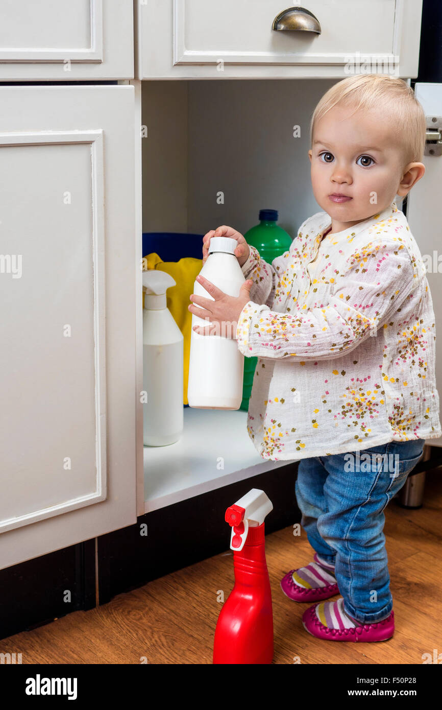 Little child playing with cleaning products at home Stock Photo - Alamy