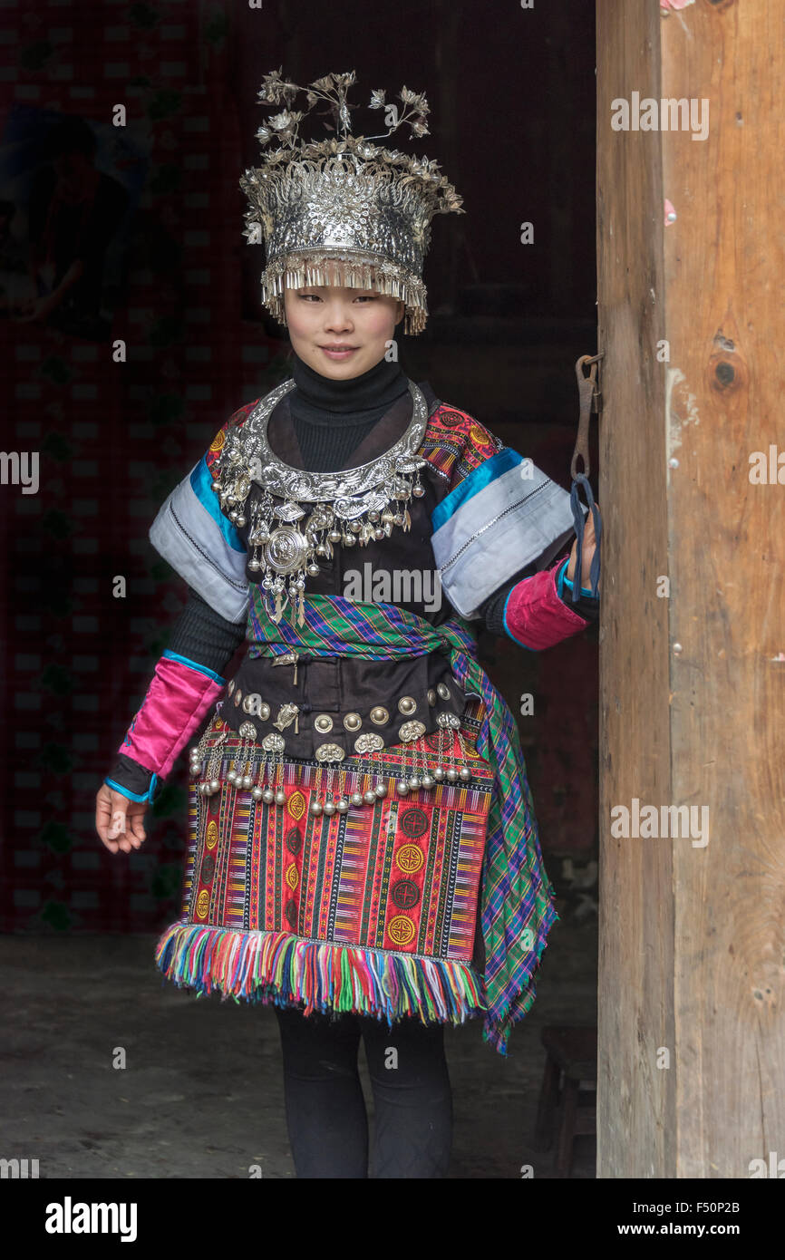 Green Medium Skirt Miao girl in traditional attire standing in a ...