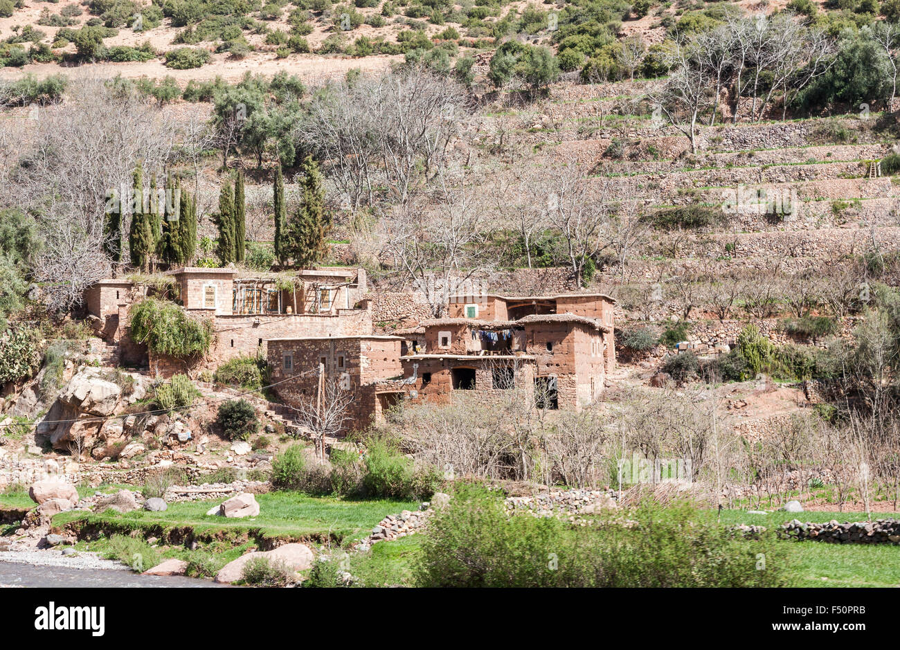 Typical Berber stone house and buildings built into the hillside in a ...