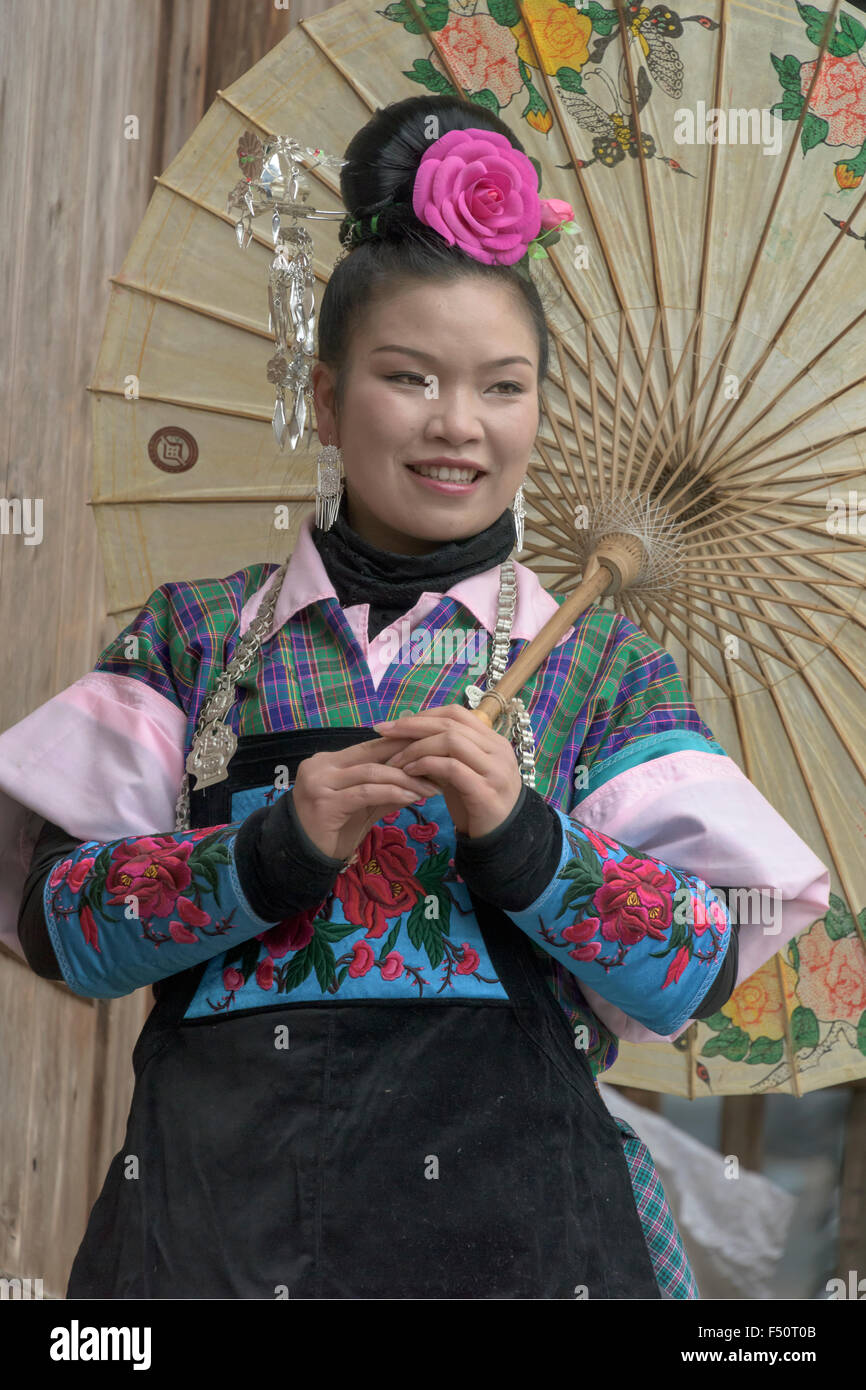 Smiling Miao girl with umbrella, Shiqiao Village, Guizhou Province ...