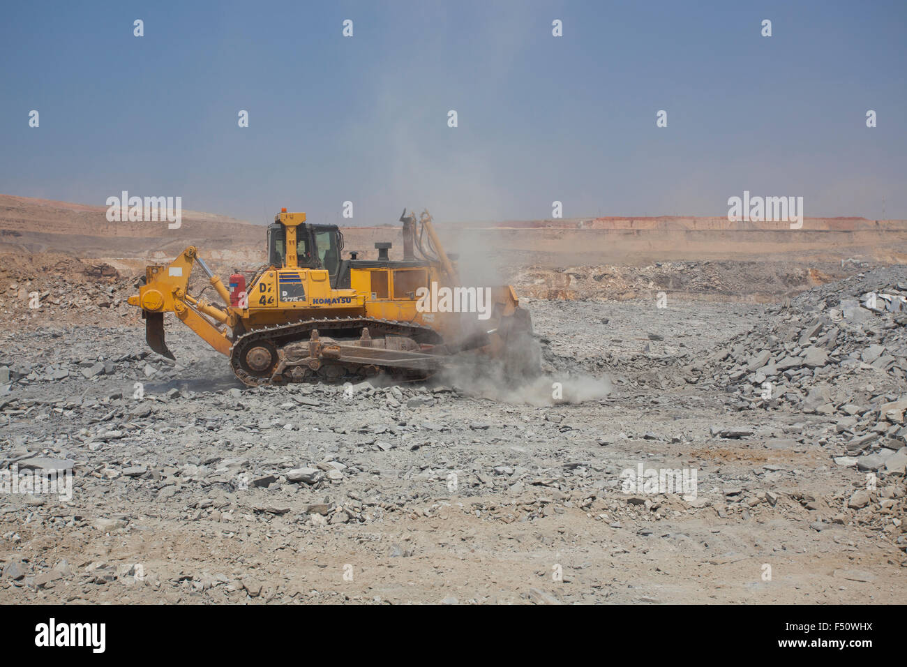 A large yellow Komatsu Crawler Tractor dozer bulldozer in action ...