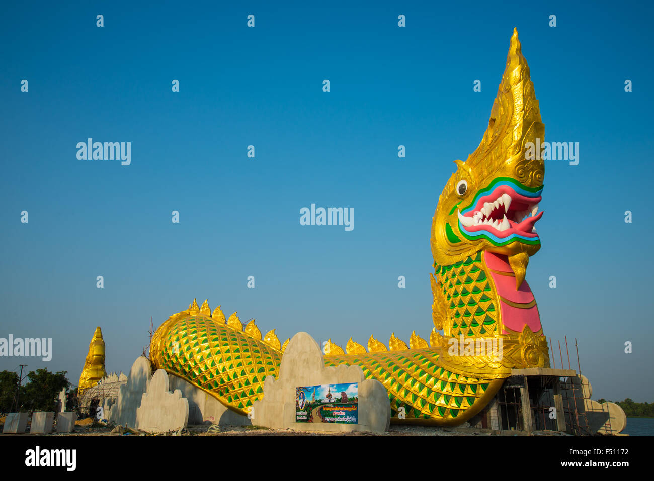 Large golden naga on the blue sky background Stock Photo - Alamy