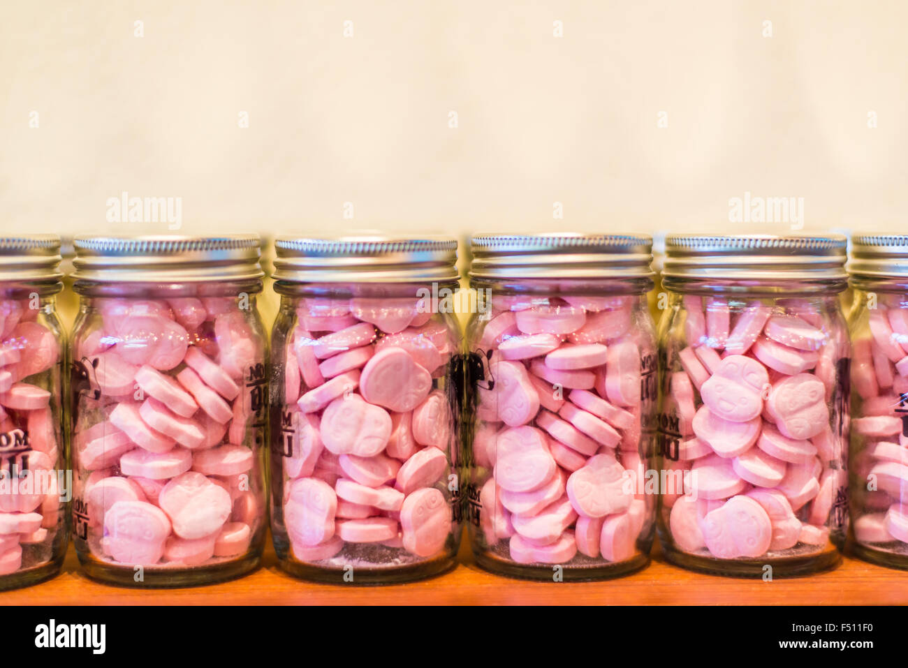 Milk tablets jar on the table, depth Stock Photo - Alamy