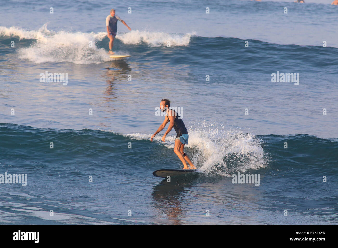 Surfers on a wave Stock Photo - Alamy