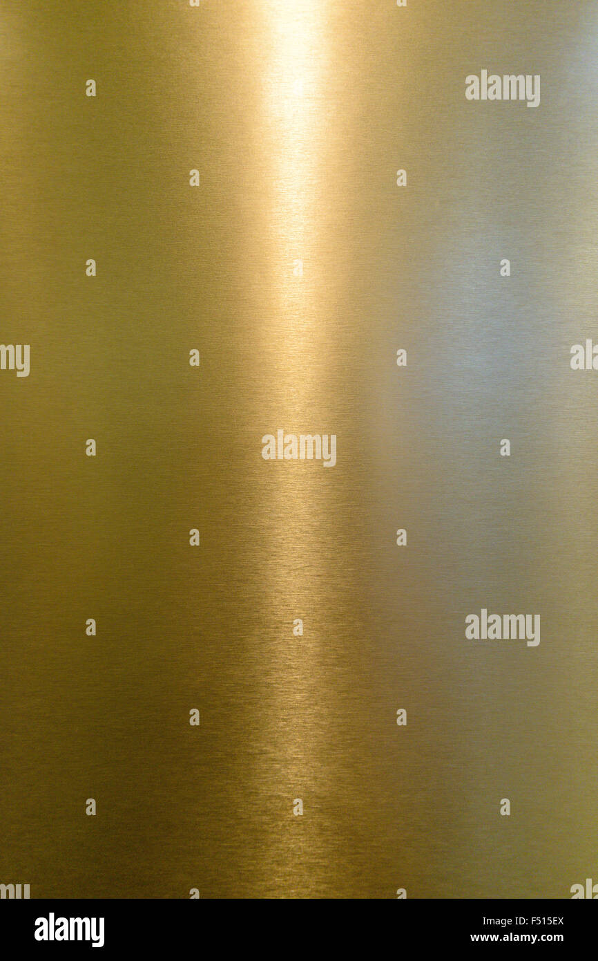 Detail of shiny polished metal surface golden (yellow) color with ...