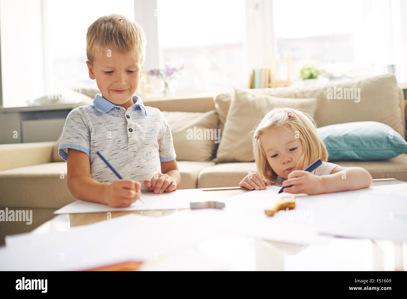 Adorable siblings drawing together at home Stock Photo - Alamy