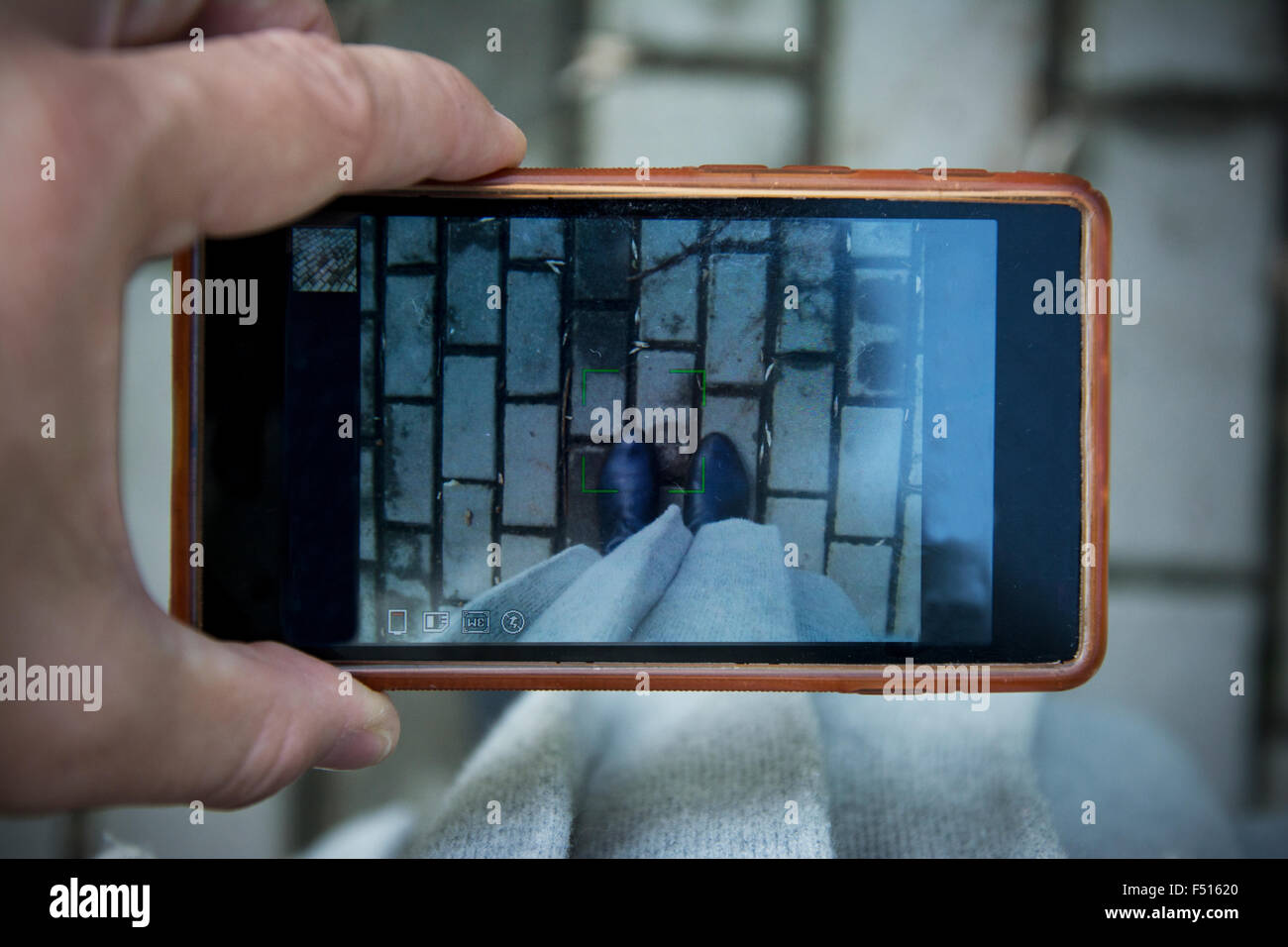 Person taking a photo with mobile photo camera, on photo boots on a ...