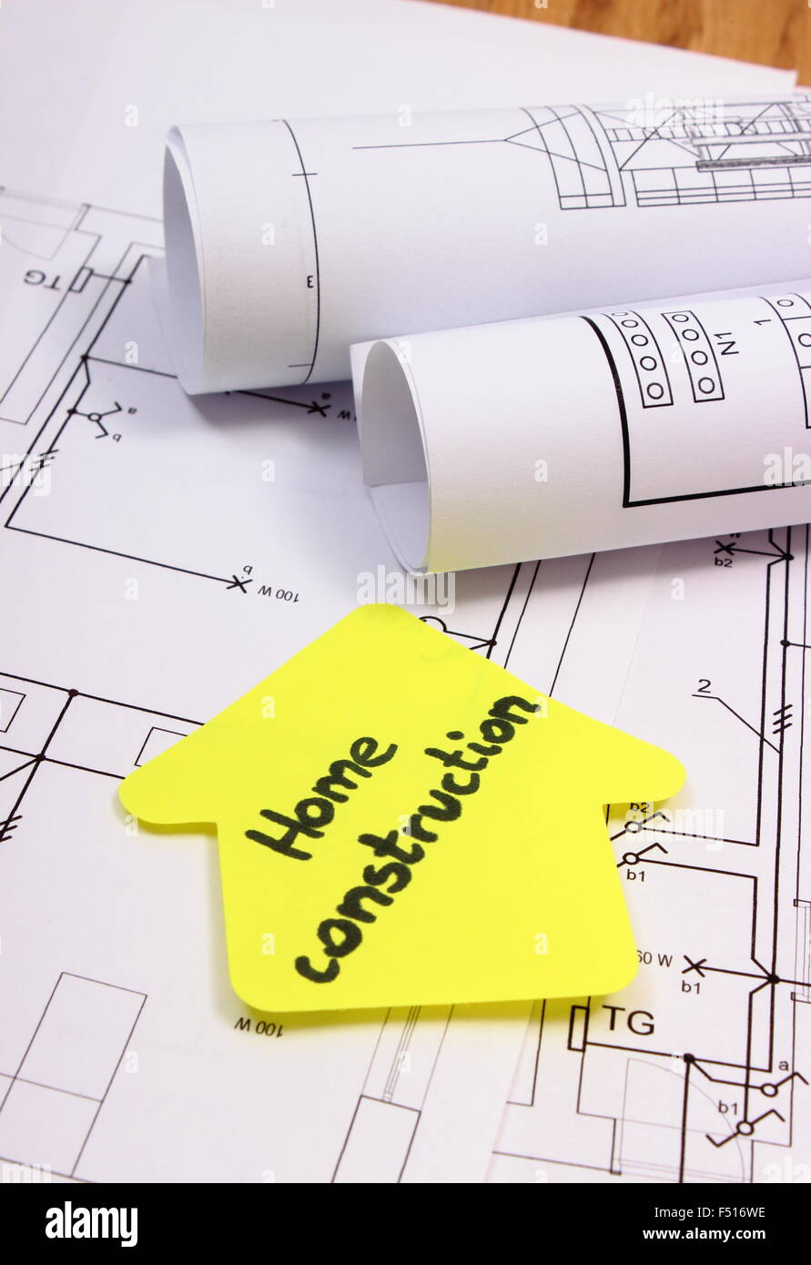 House of yellow paper with text home construction and rolls of diagrams ...