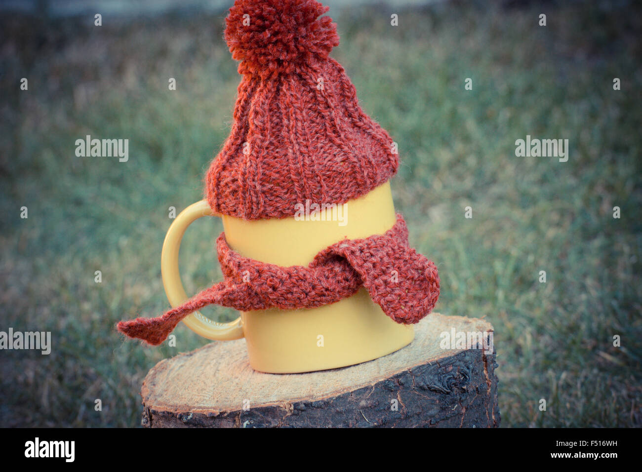 Vintage photo, Yellow cup of hot tea with woolen cap wrapped woolen ...