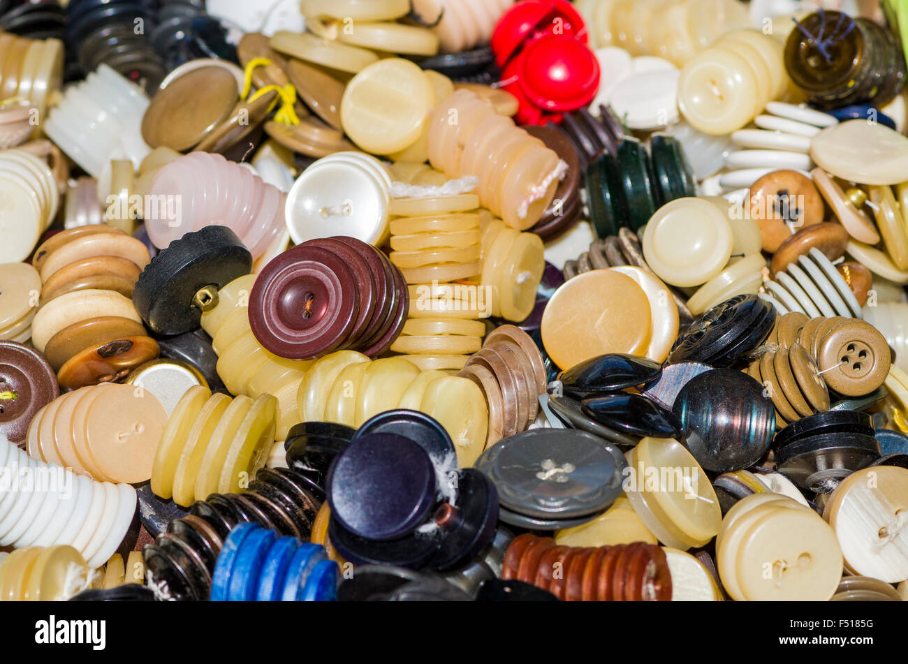 A bunch of colorful buttons are offered for sale at the weekly flea ...