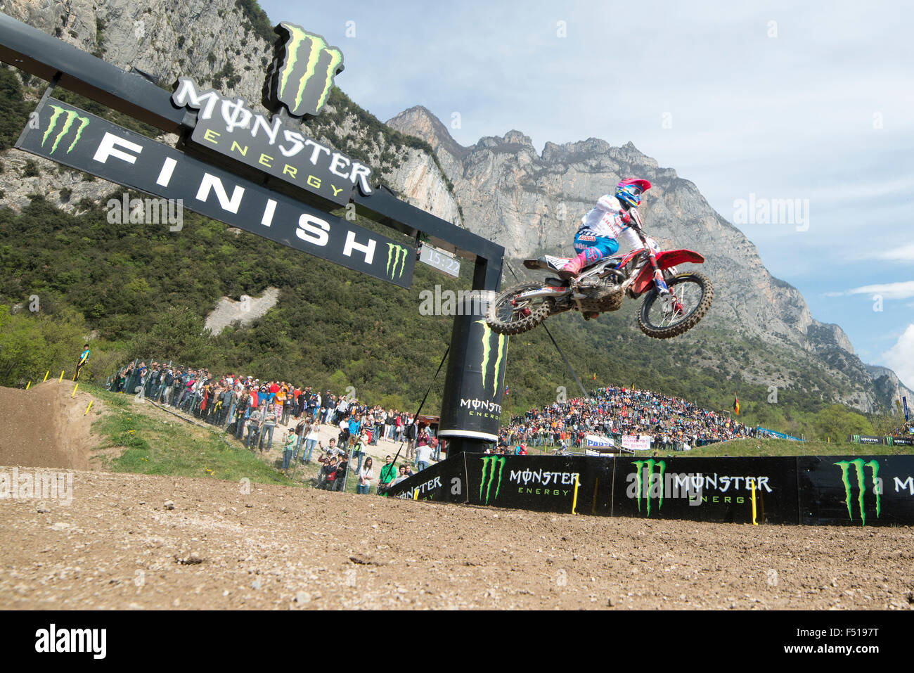 A motorcyclist on a motocross bike is jumping through the air during ...