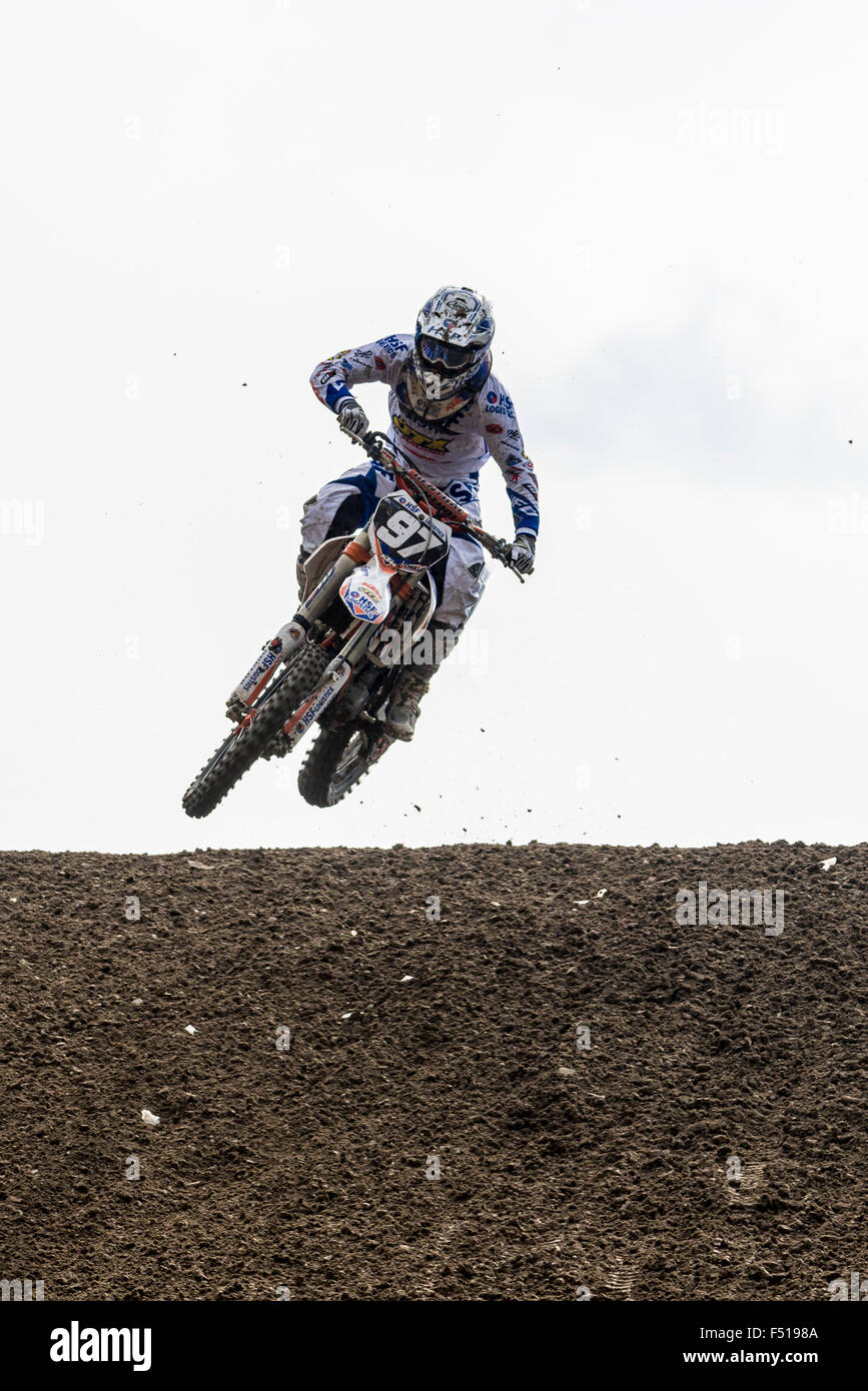 A motorcyclist on a motocross bike is jumping through the air during ...