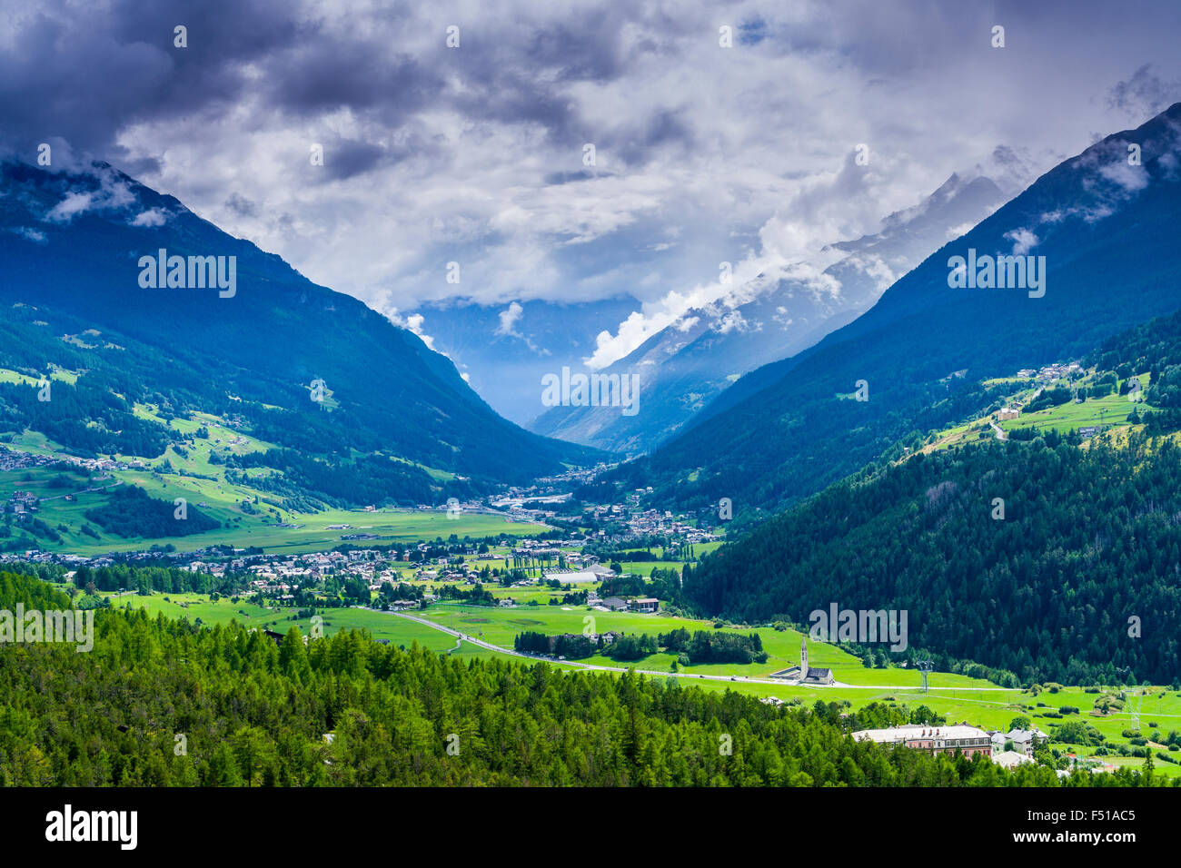 The town is located at the bottom of a narrow valley, surrounded by ...
