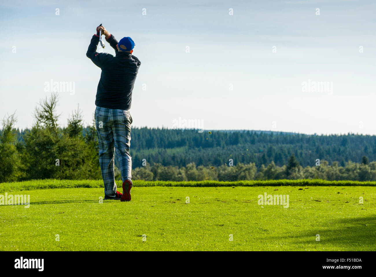 A man is playing golf on a green meadow Stock Photo - Alamy