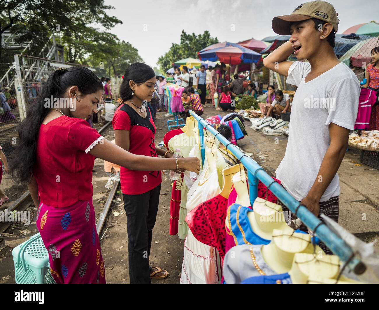 Insein, Yangon Division, Myanmar. 25th Oct, 2015. A man sells women's ...