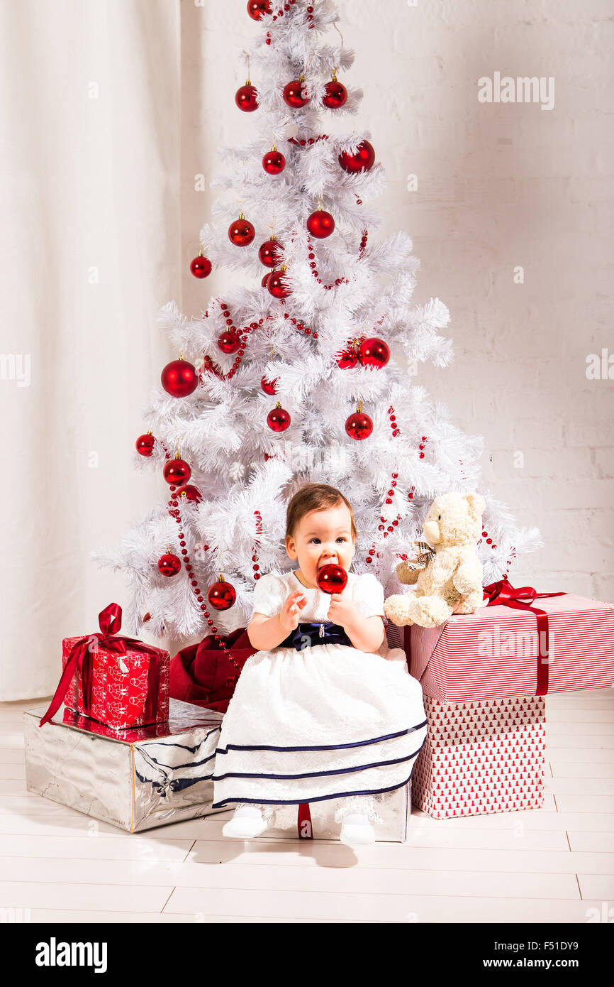 pretty little girl under the new year tree Stock Photo - Alamy