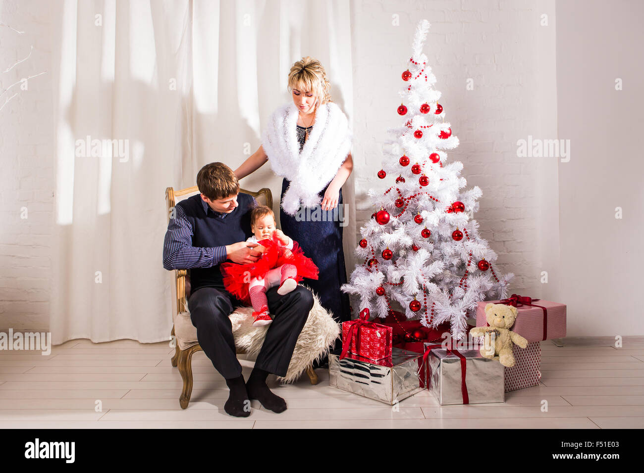 Portrait of happy family with Christmas tree Stock Photo - Alamy