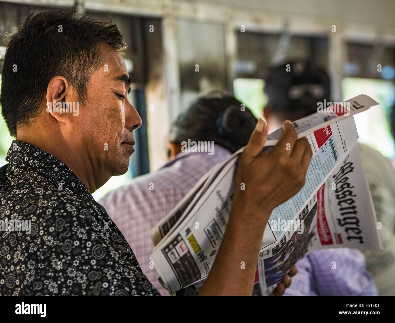 Yangon, Yangon Division, Myanmar. 26th Oct, 2015. A man reads a ...