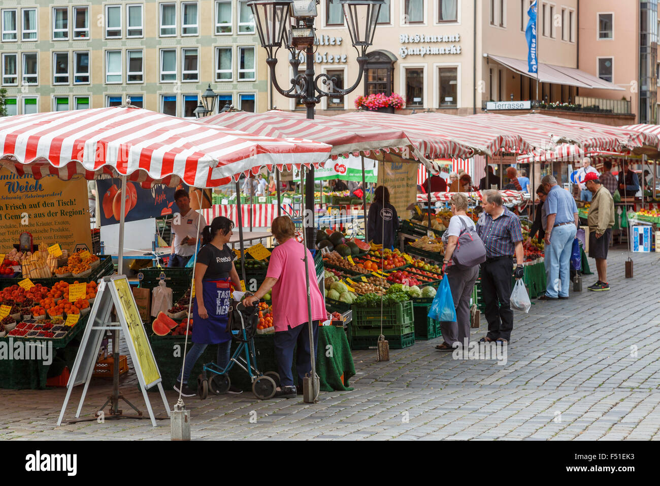 Stalls and shoppers at the historic marketplace in Nuremberg, Germany ...